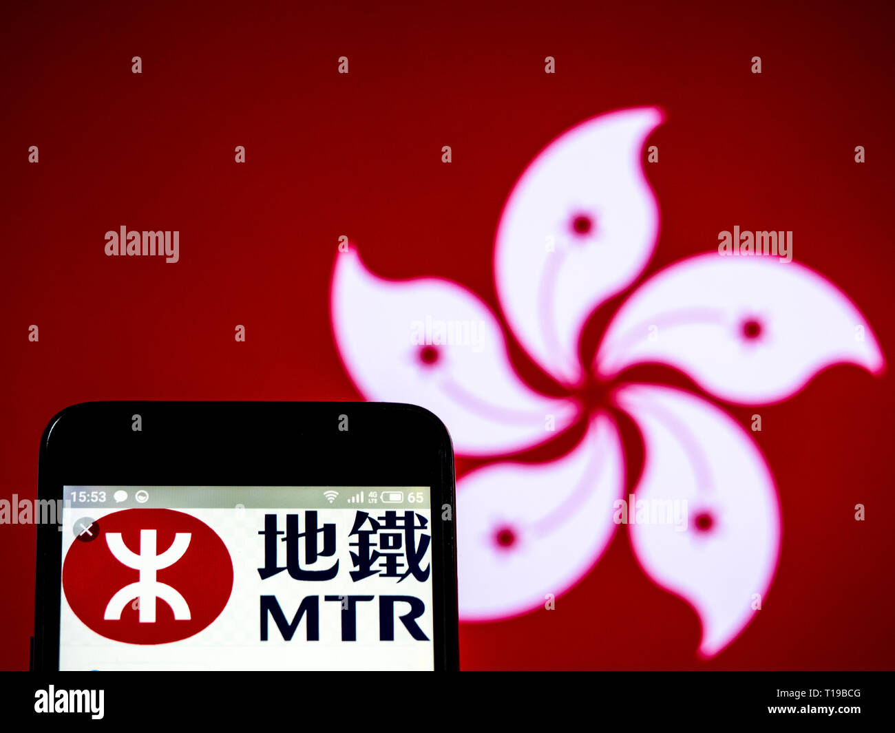 In this photo illustration a MTR Corporation logo seen displayed on a ...