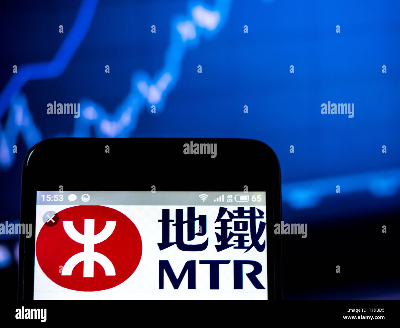 In this photo illustration a MTR Corporation logo seen displayed on a ...