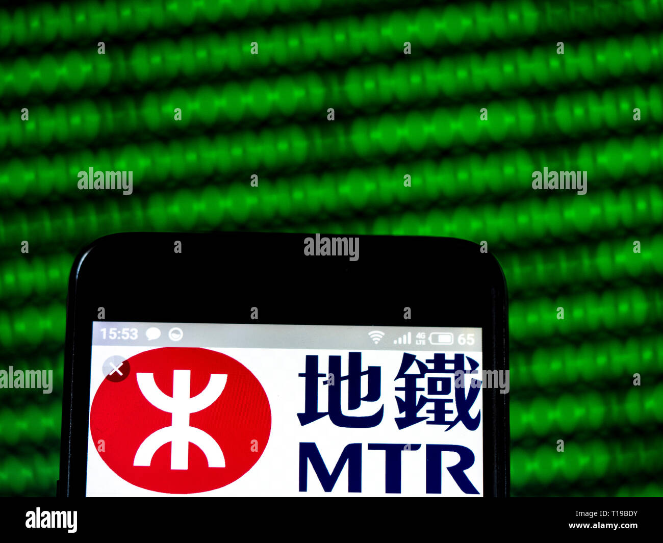 In this photo illustration a MTR Corporation logo seen displayed on a ...