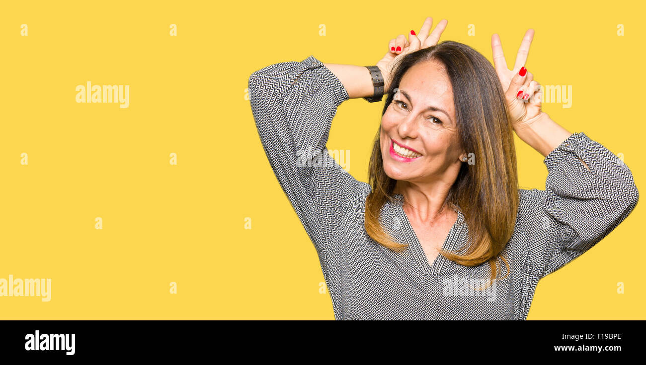Beautiful middle age business woman Posing funny and crazy with fingers ...