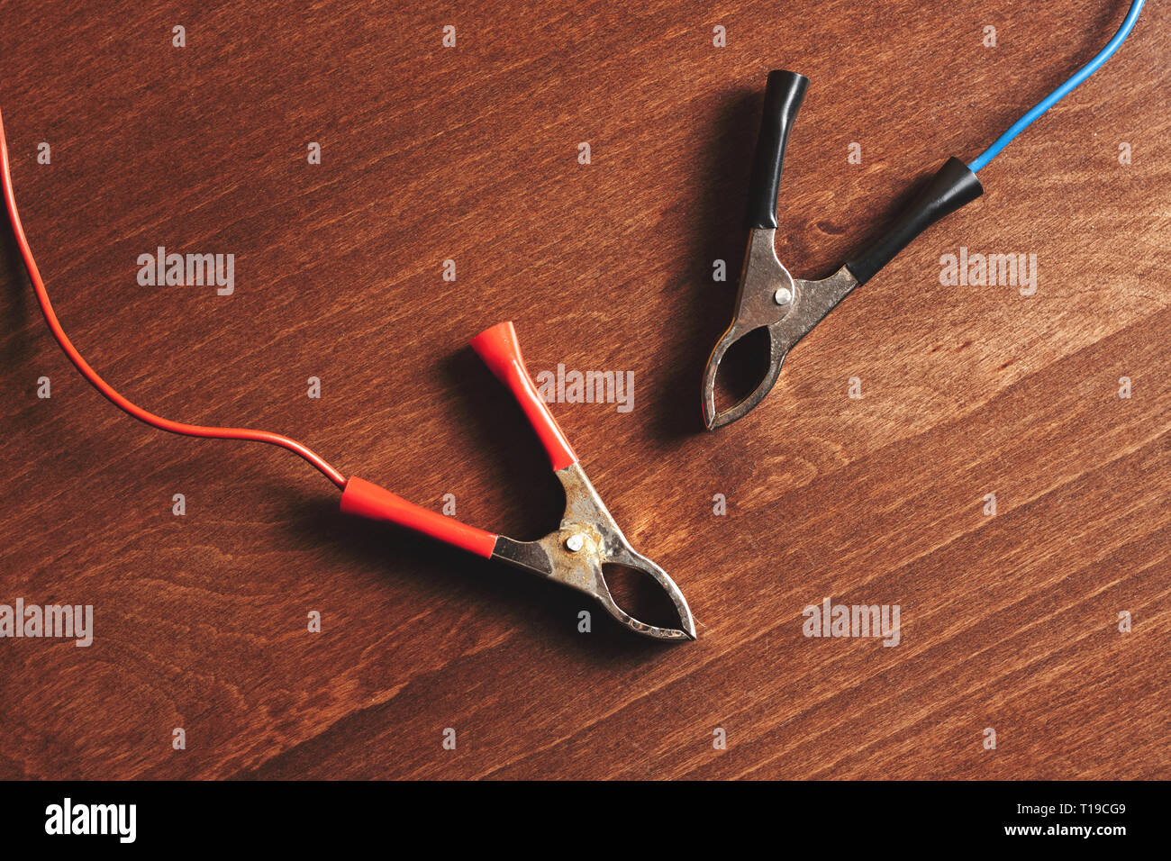charger battery clips. Close up red and black clips. toned. charging ...