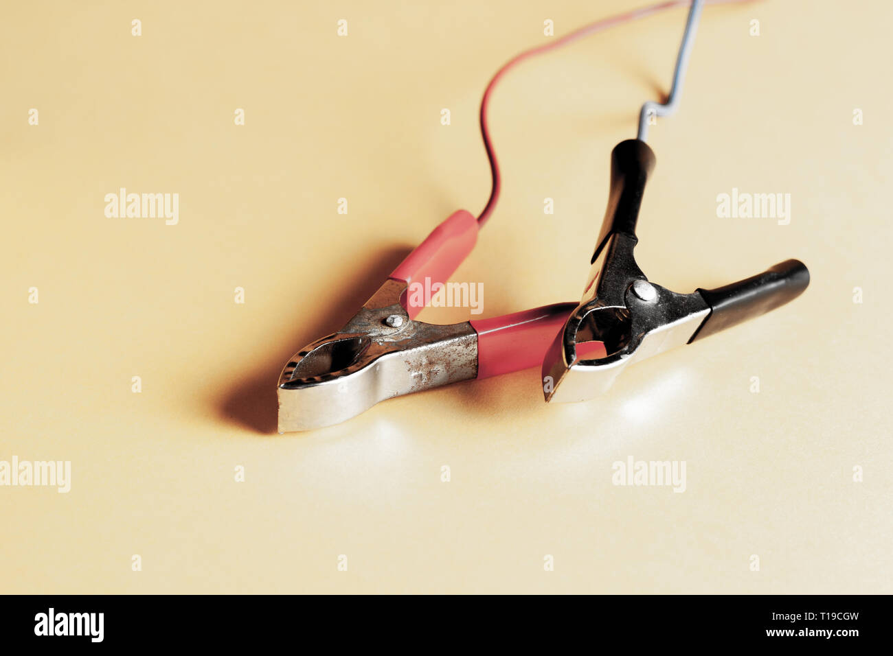 recharging battery clips charger. Close up red and black clips. toned ...