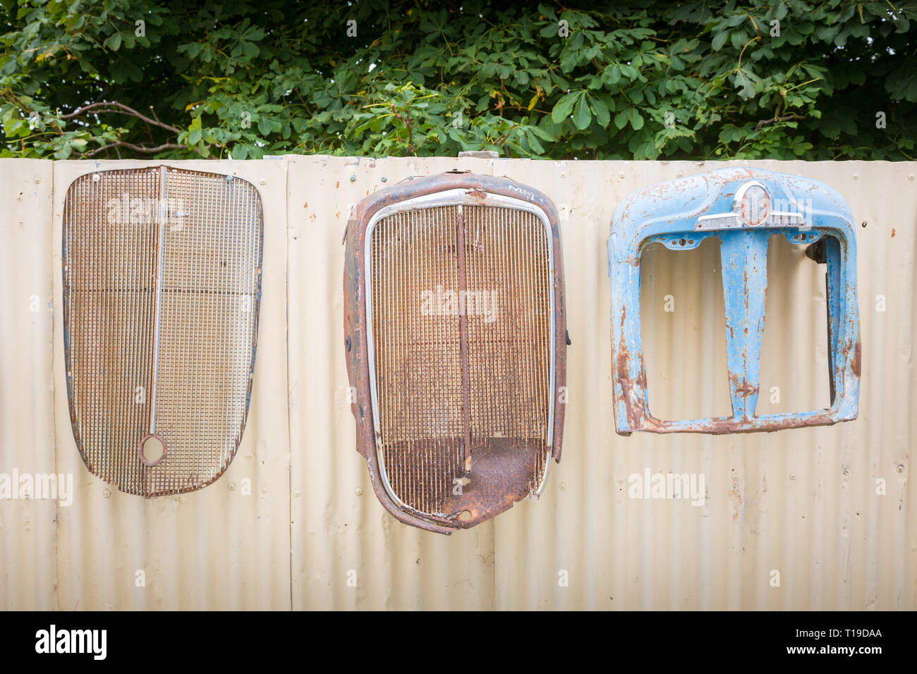 Old classic radiator grilles from cars on a fence, New Zealand Stock ...