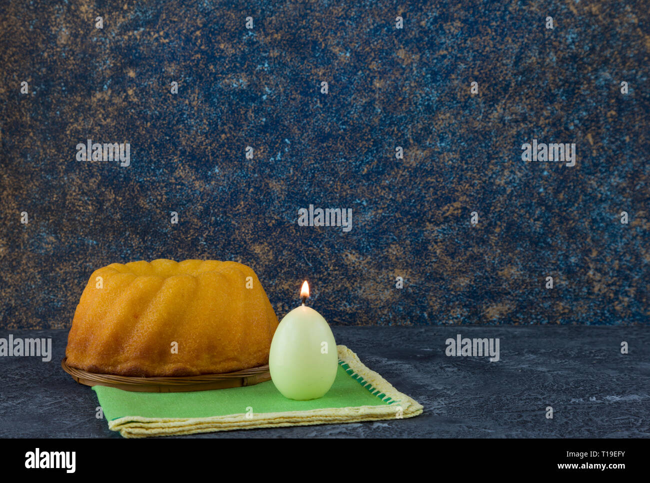 Easter bread and egg shaped candles on dark stone table Stock Photo - Alamy