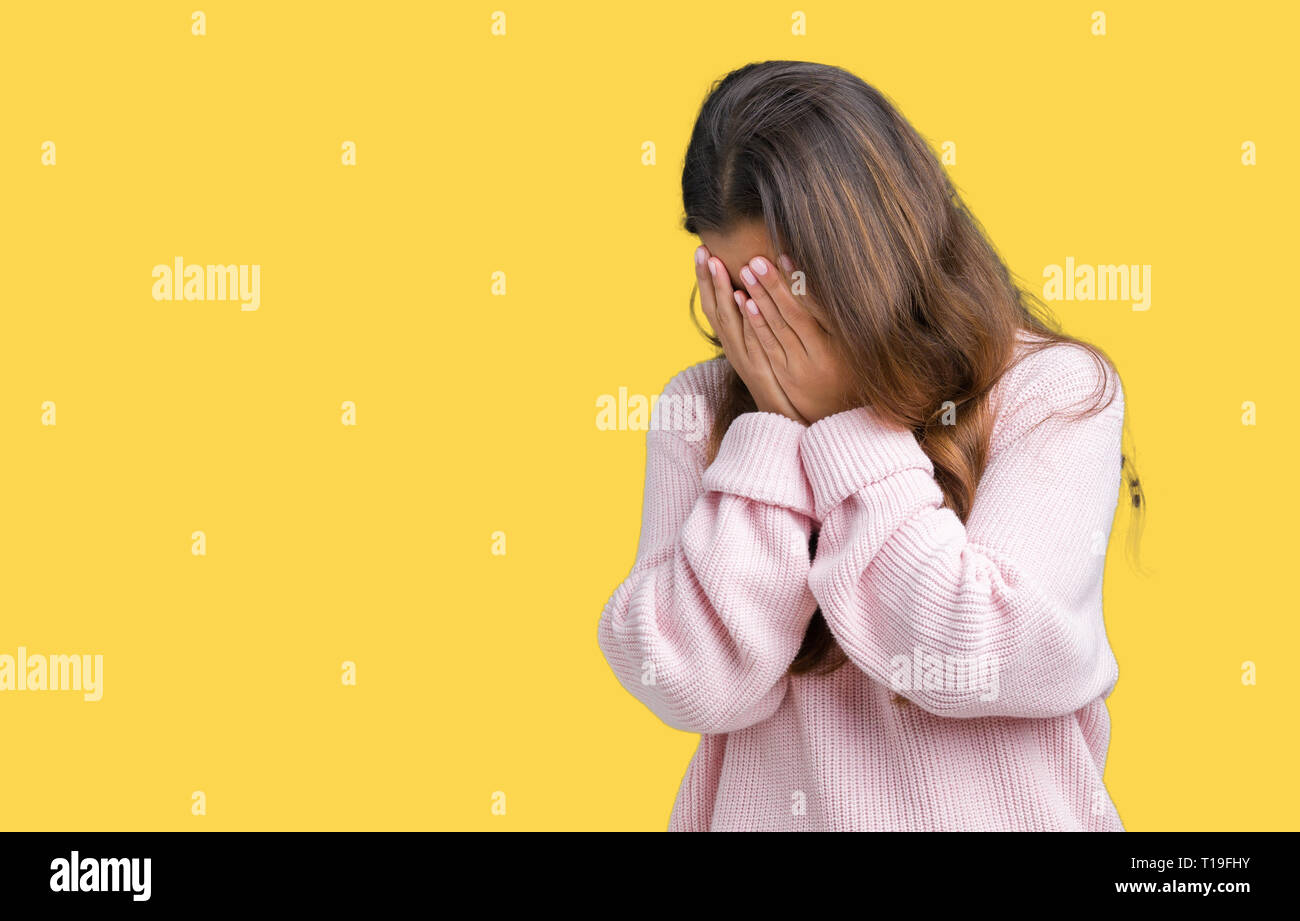 Young beautiful brunette woman wearing pink winter sweater over ...