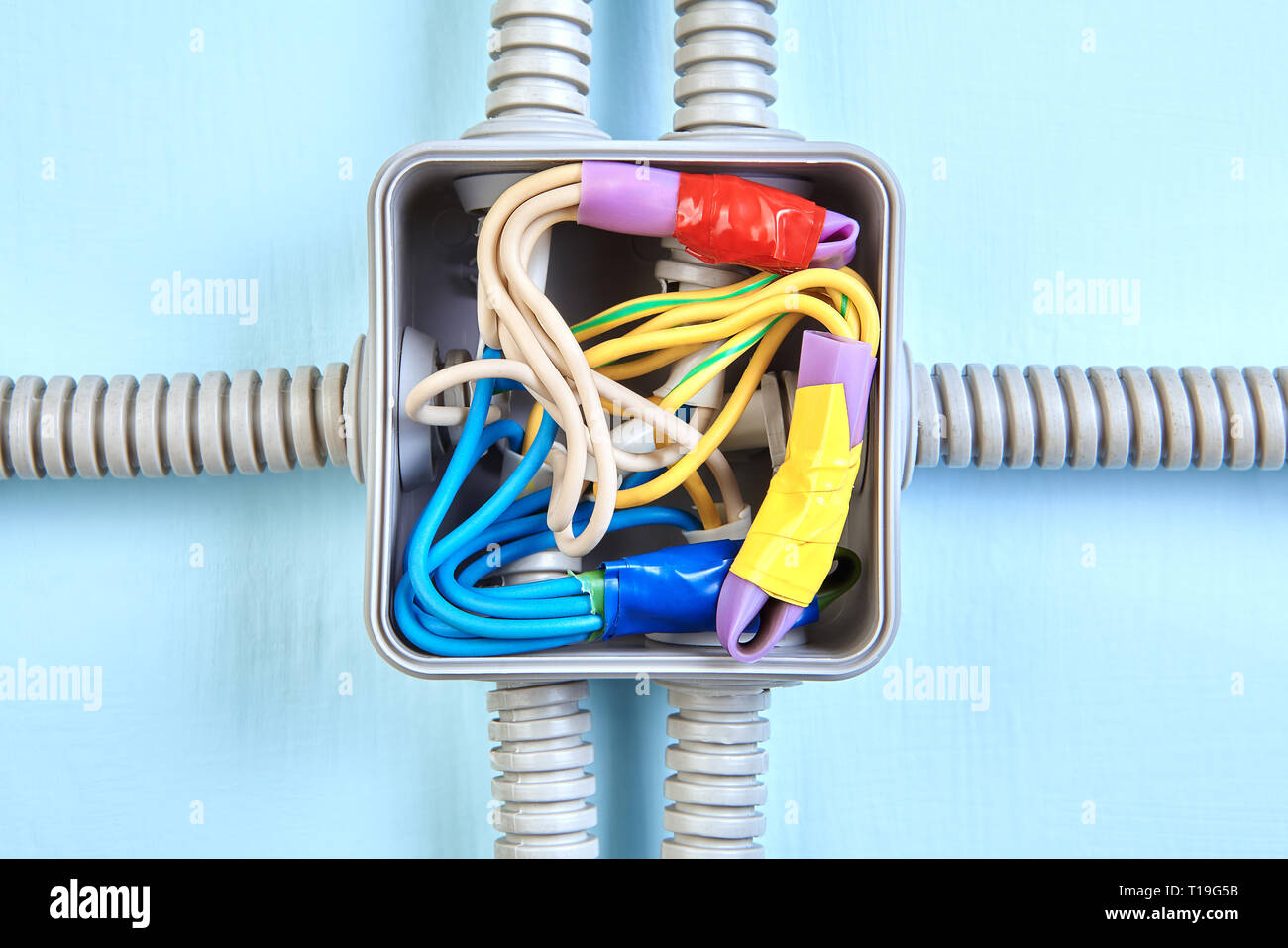 Surface-mounted extension box with taped wires with heat shrink tubing ...