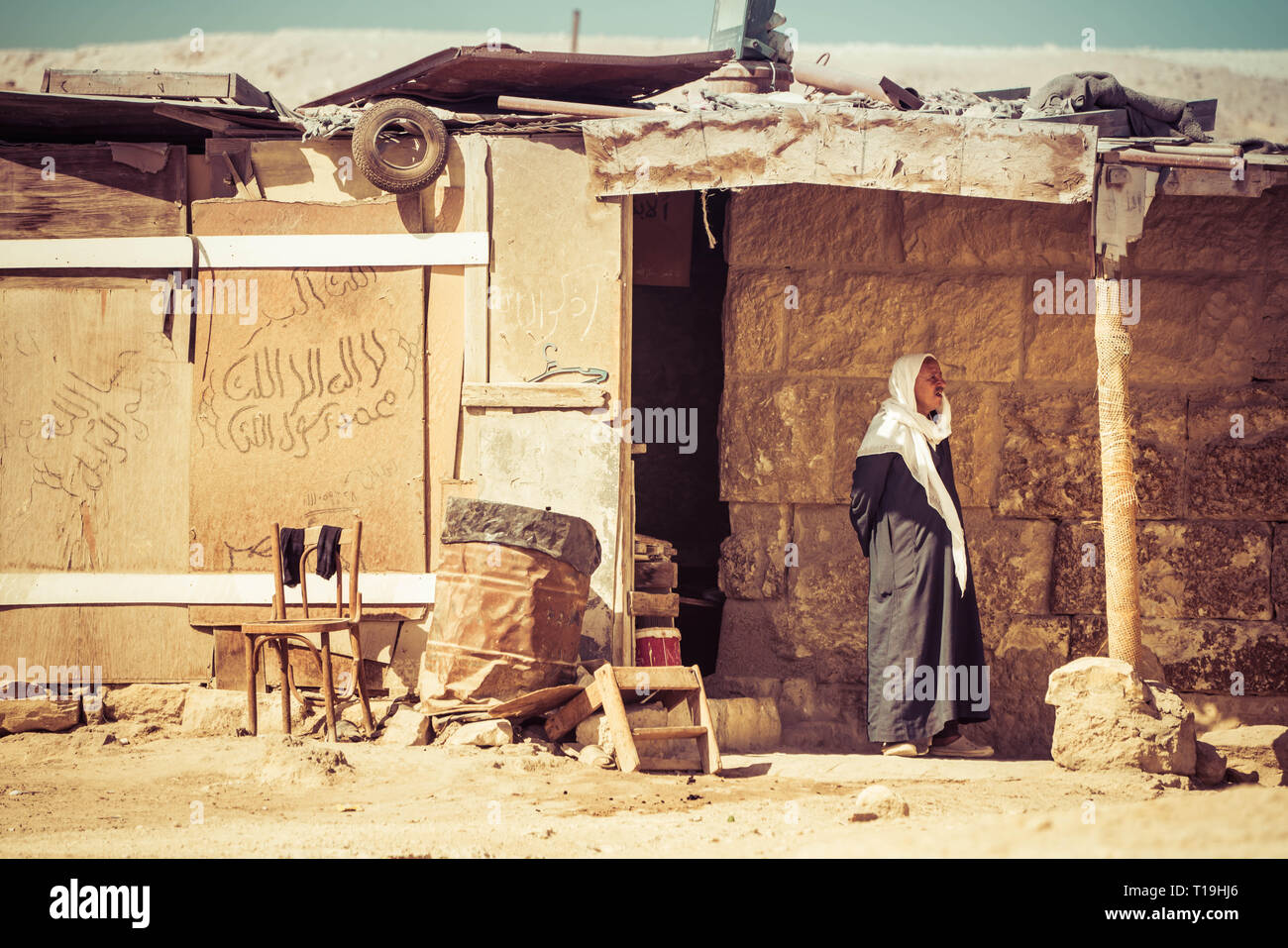 A local man outside of his house at the foot of the Great Pyramids at ...