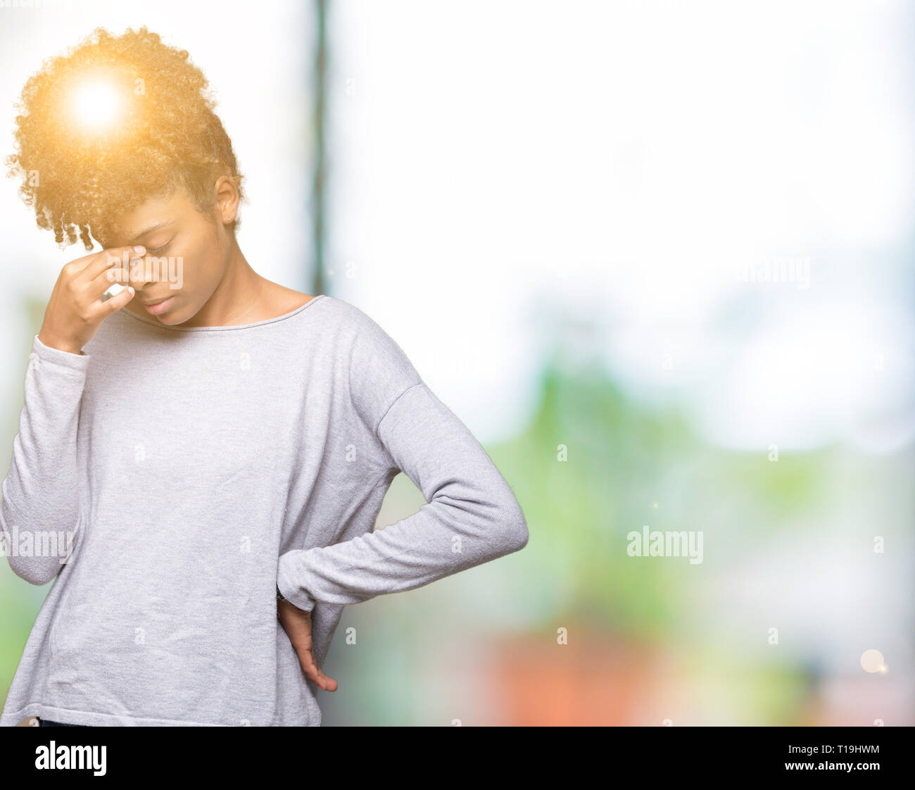 Beautiful young african american woman over isolated background tired ...