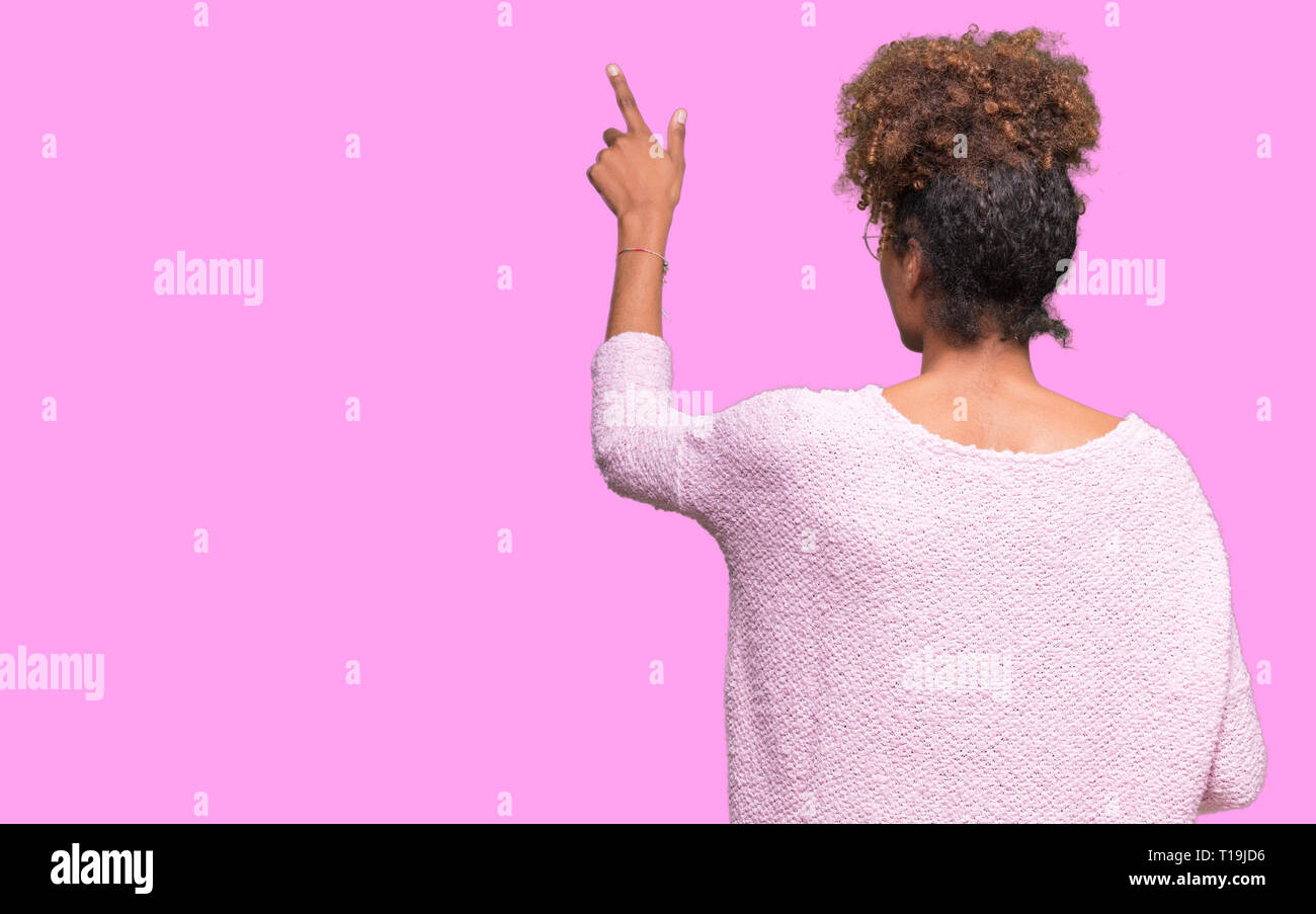 Portrait young woman pointing backwards hi-res stock photography and ...