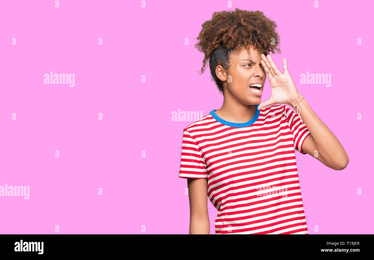 Beautiful young african american woman over isolated background ...