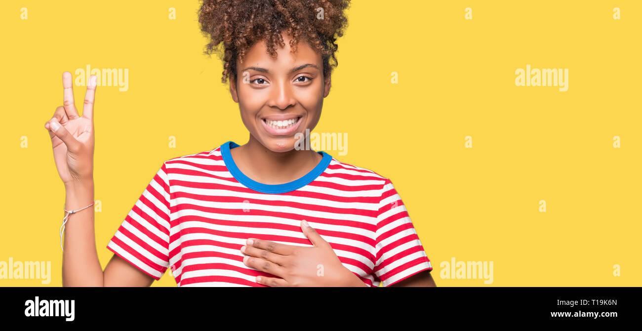Beautiful young african american woman over isolated background ...