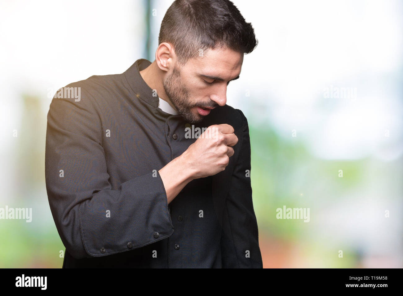 Young Christian priest over isolated background feeling unwell and ...