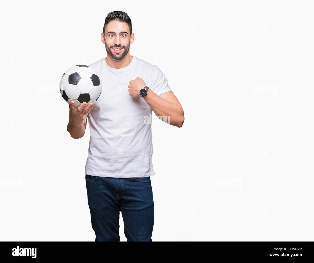 Young man holding soccer football ball over isolated background with ...