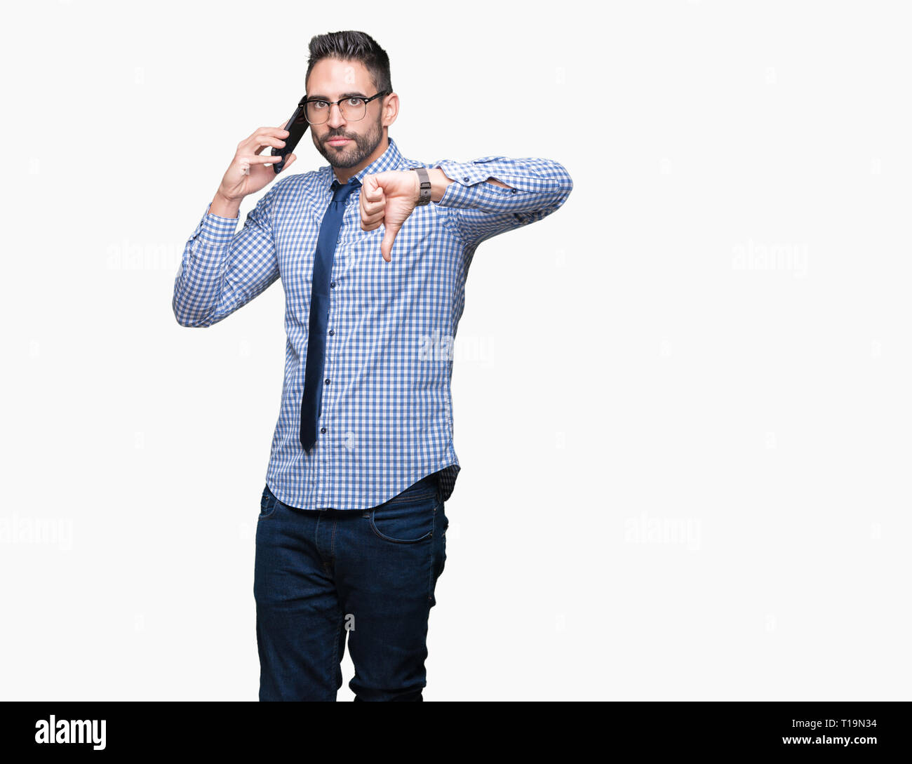 Young business man talking on the phone over isolated background with ...