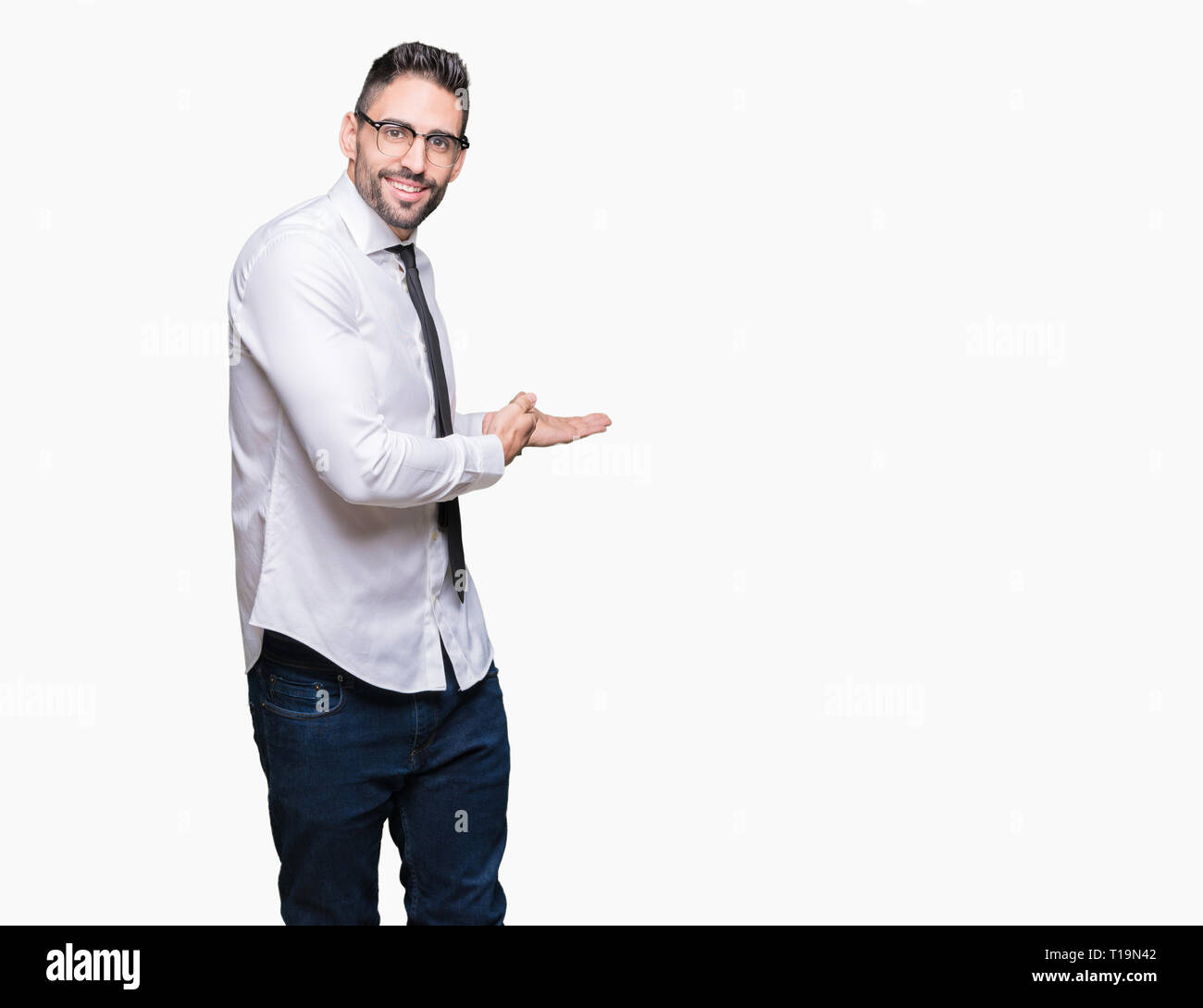 Young handsome business man wearing glasses over isolated background ...