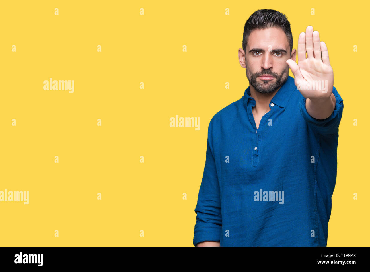 Young handsome man over isolated background doing stop sing with palm ...