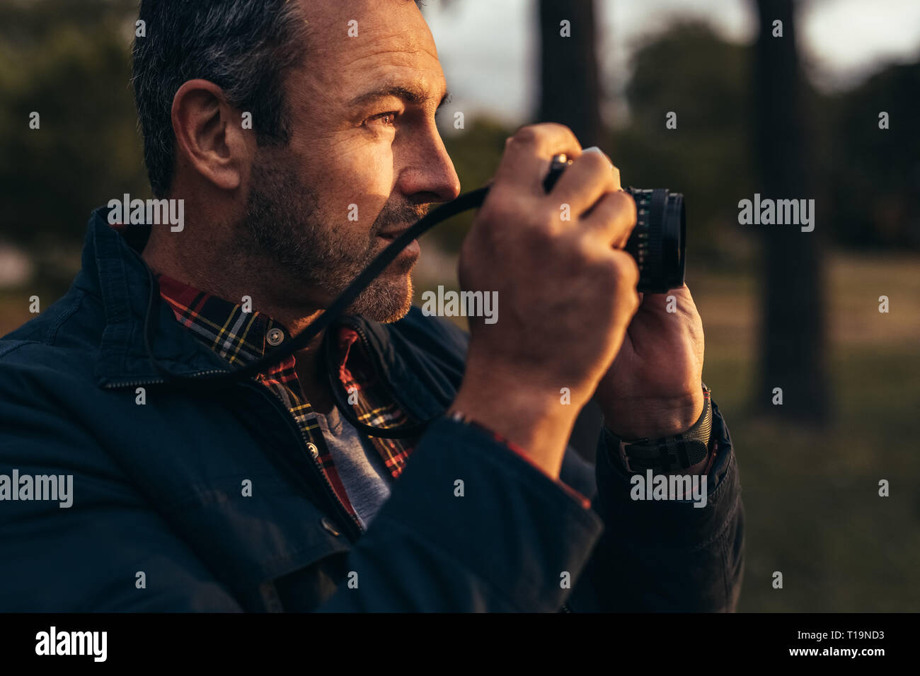 Close up of a man capturing the beauty of nature in a camera. Cropped ...