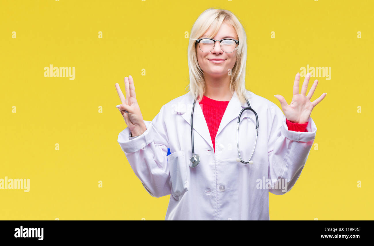 Young beautiful blonde doctor woman wearing medical uniform over ...
