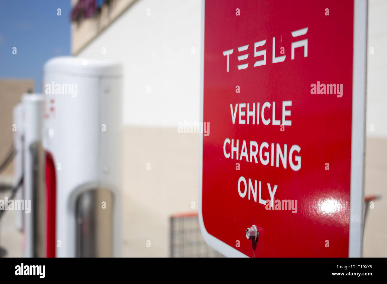Tesla Supercharging Station in Fountain Valley, California, a red sign ...