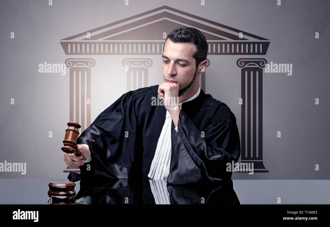 Young judge in front of a courthouse symbol making decision Stock Photo ...