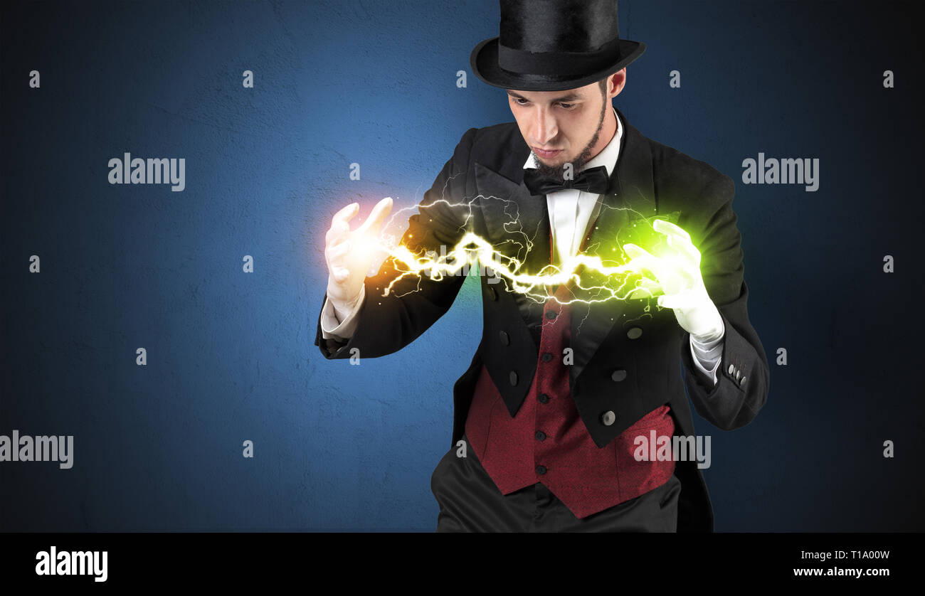 Magician sparkling super power between his two hands Stock Photo - Alamy