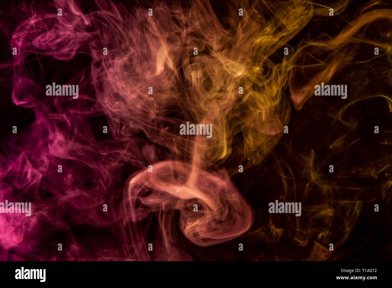 Frozen abstract movement of explosion yellow and pink smoke multiple ...