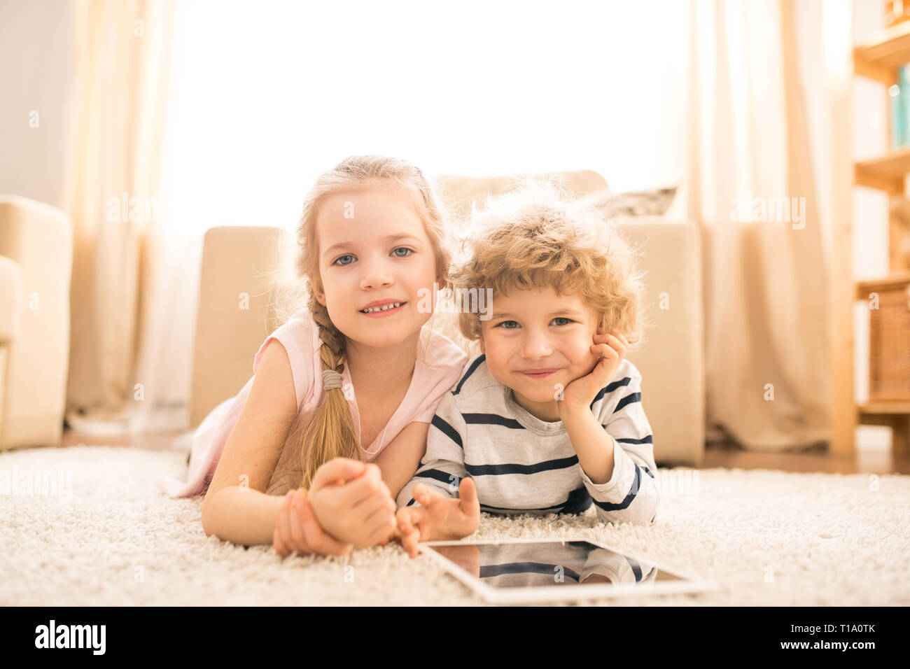 Siblings at home Stock Photo - Alamy