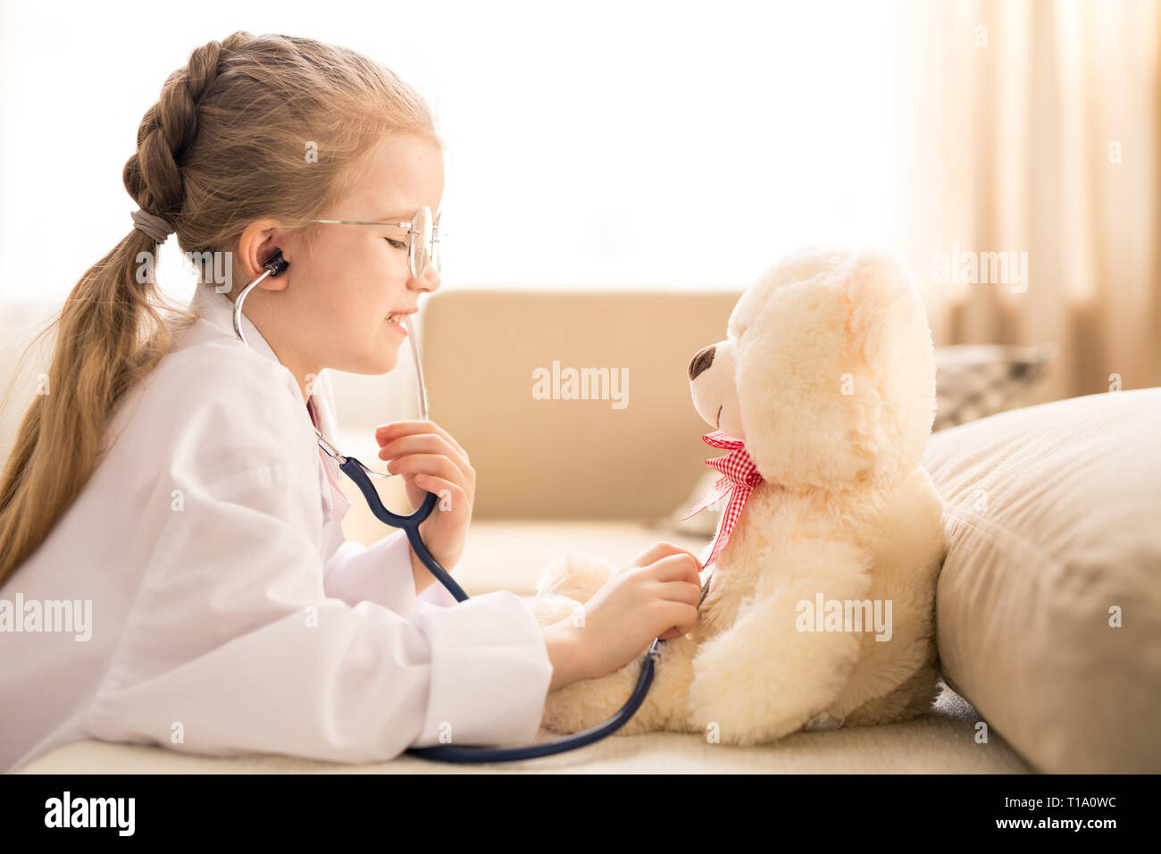 Girl child playing doctor hi-res stock photography and images - Alamy