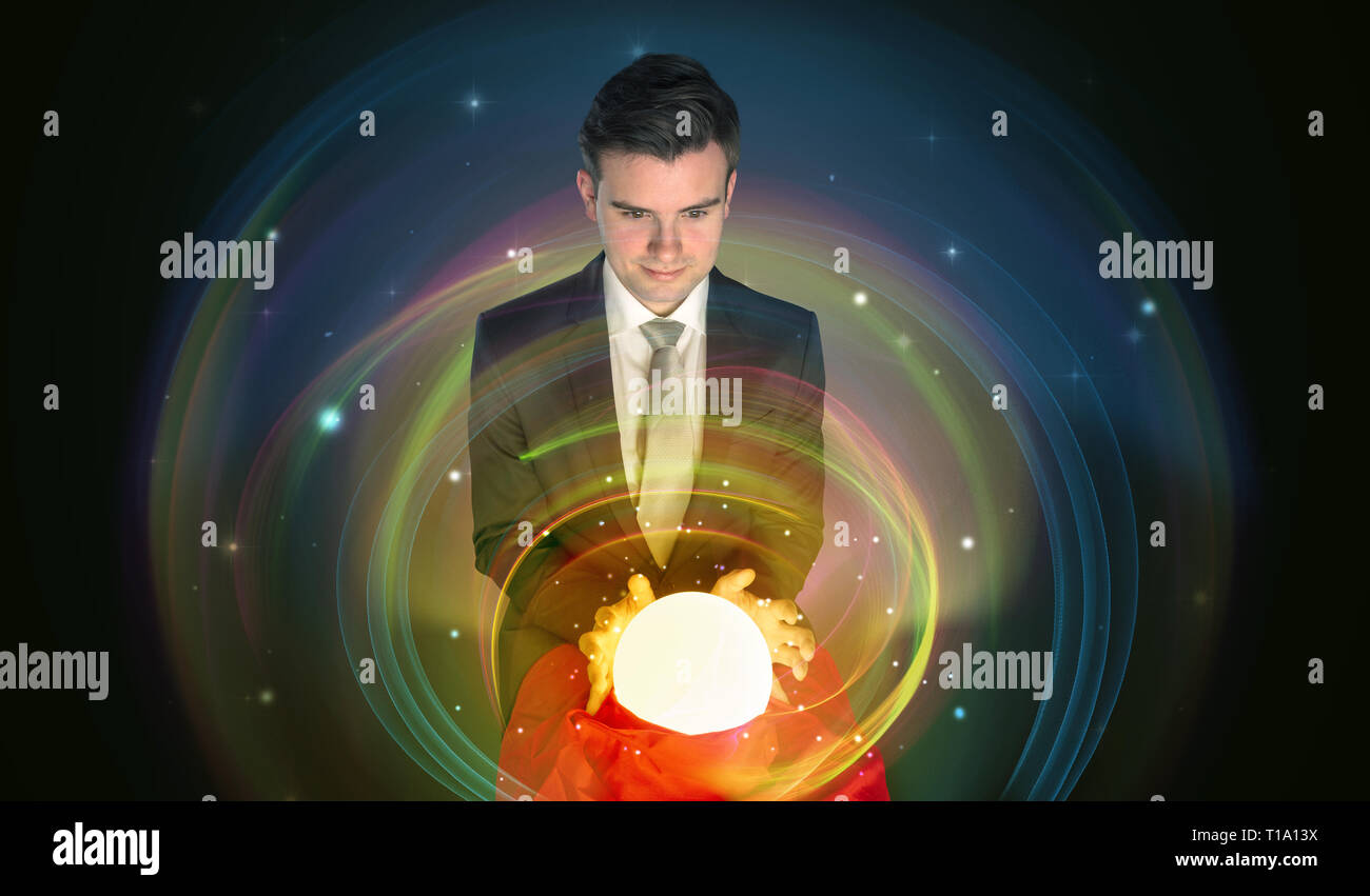 Young handsome man looking to the future of the universe in a crystal ...