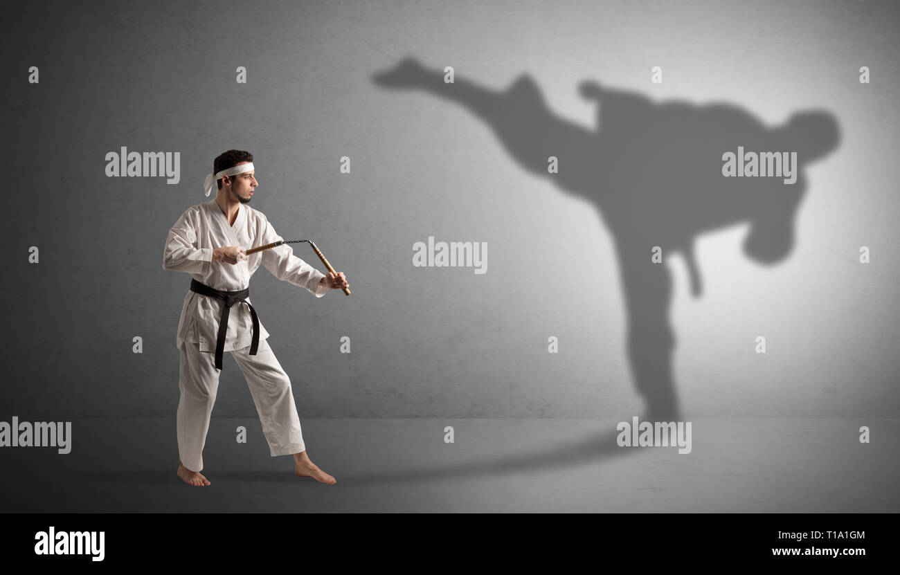 Young karate man confronting with his own shadow Stock Photo - Alamy