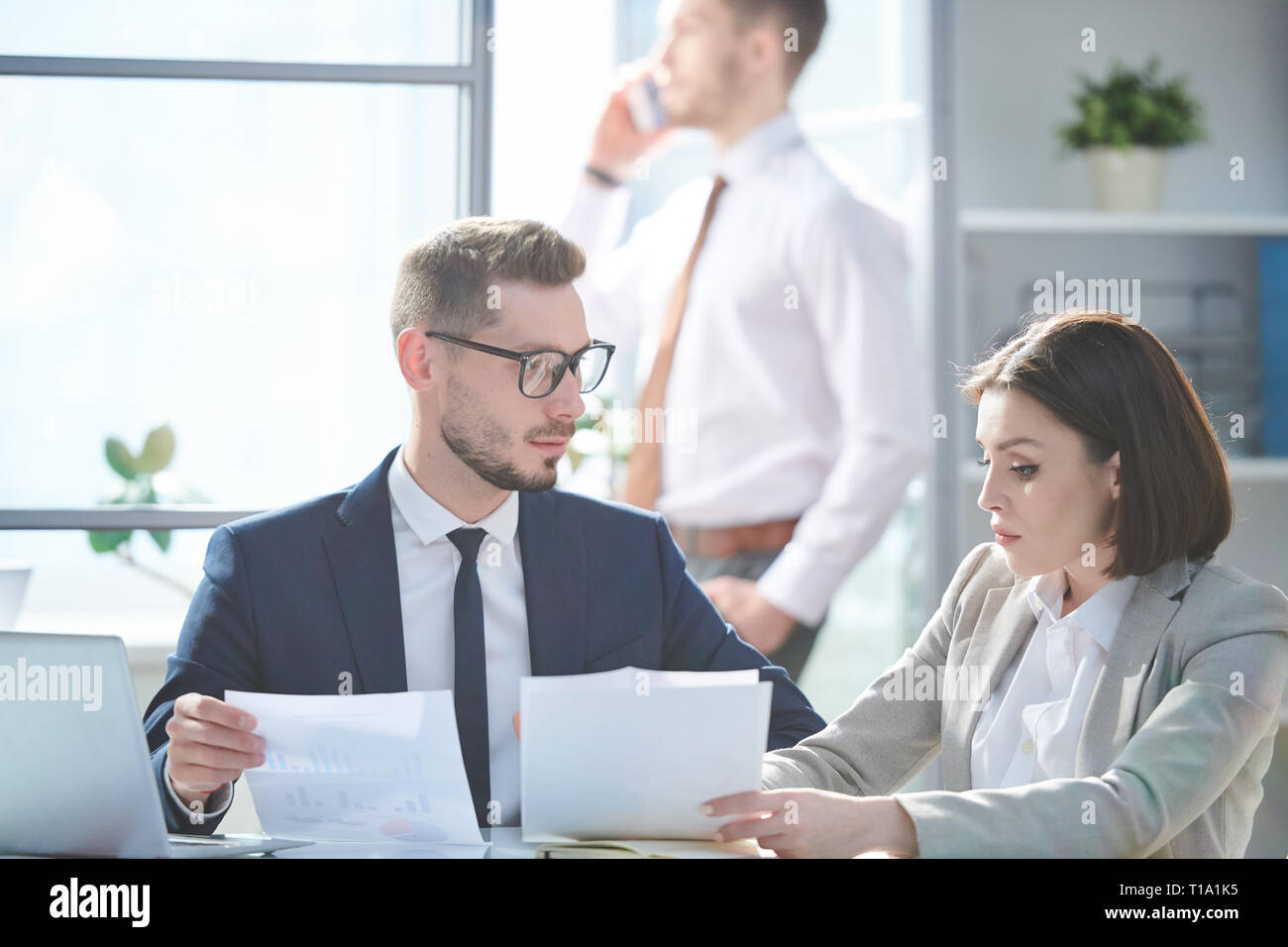 Looking through business documents Stock Photo - Alamy