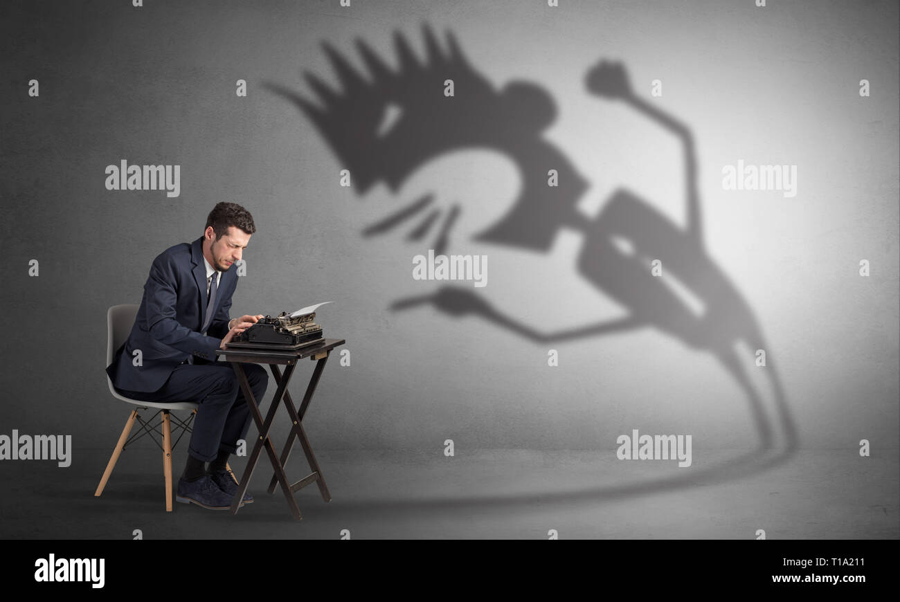 Man working hard and he is afraid of a yelling shadow Stock Photo - Alamy
