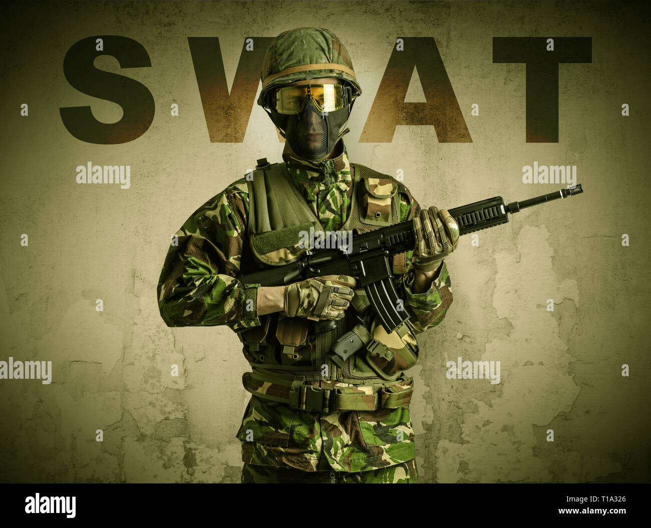 Uniformed armed soldier with damaged wall background Stock Photo - Alamy