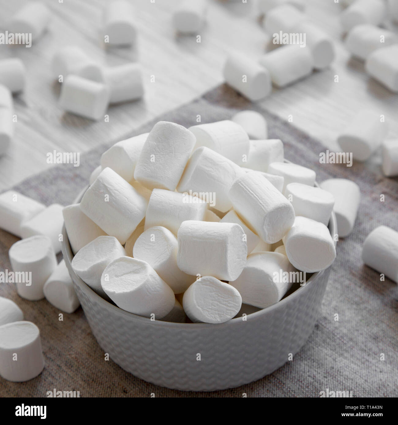 Fluffy white marshmallows in a gray bowl, side view. Close-up Stock ...