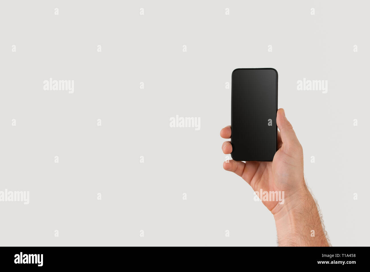 man holding cell phone , mobile phone with blank screen and copy space ...