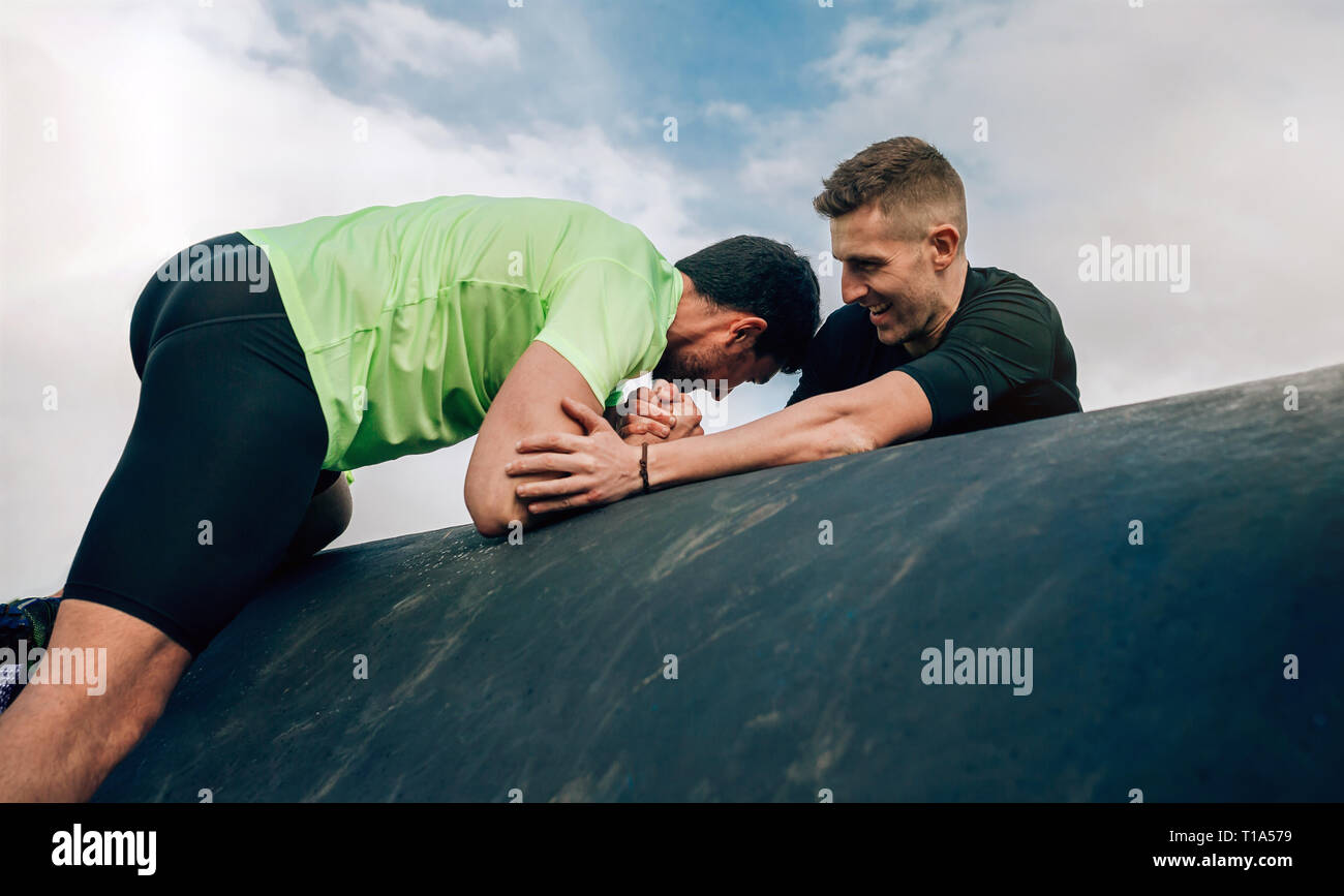 Strong obstacle people climbing hi-res stock photography and images - Alamy