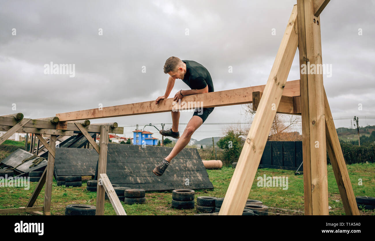 Participant in a obstacle course doing irish table Stock Photo - Alamy