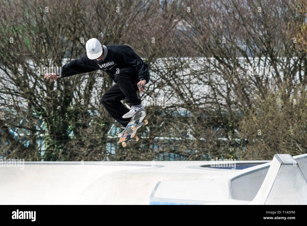 A skateboarder performing an aerial trick at Concrete Waves Skateboard ...