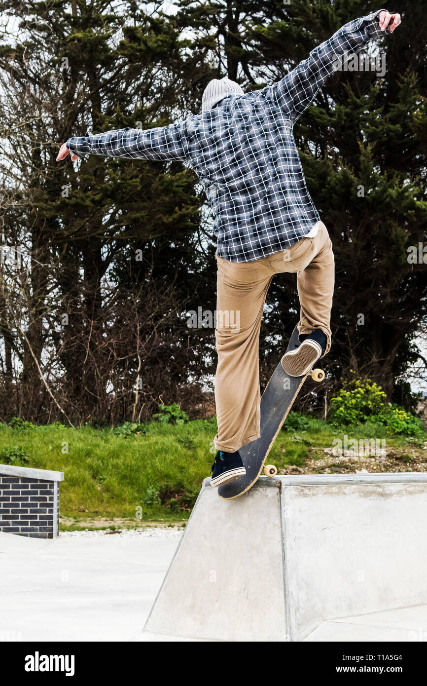 A skateboarder performing a trick at Concrete Waves Skateboard Park in ...