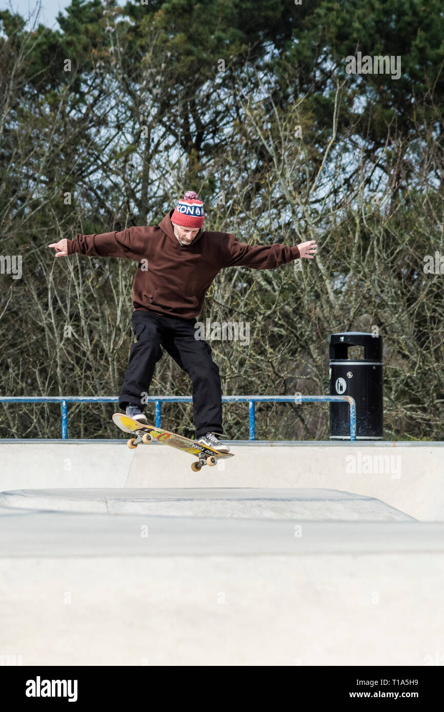 A skateboarder performing an aerial trick at Concrete Waves Skateboard ...