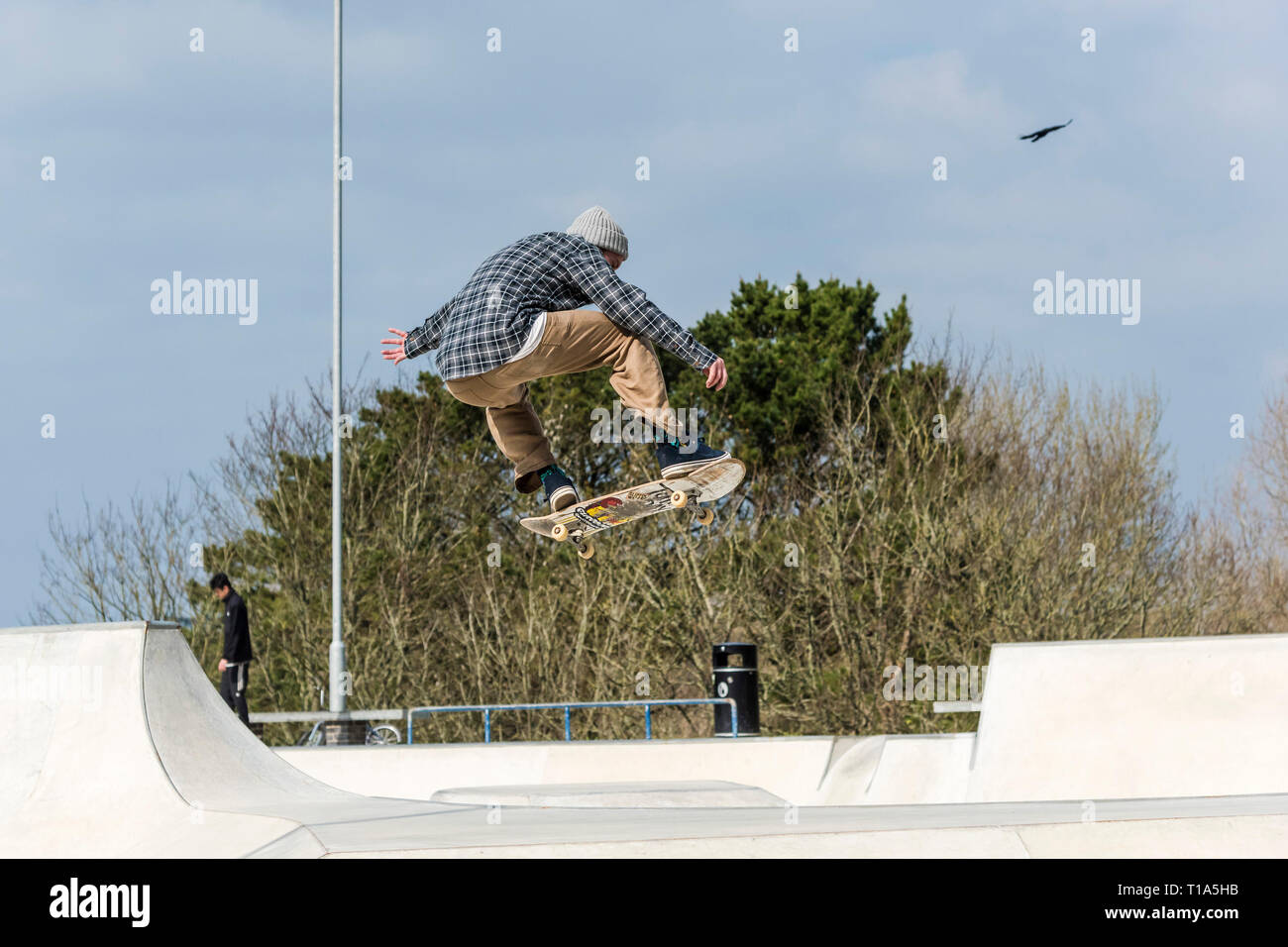 A skateboarder performing an aerial trick at Concrete Waves Skateboard ...