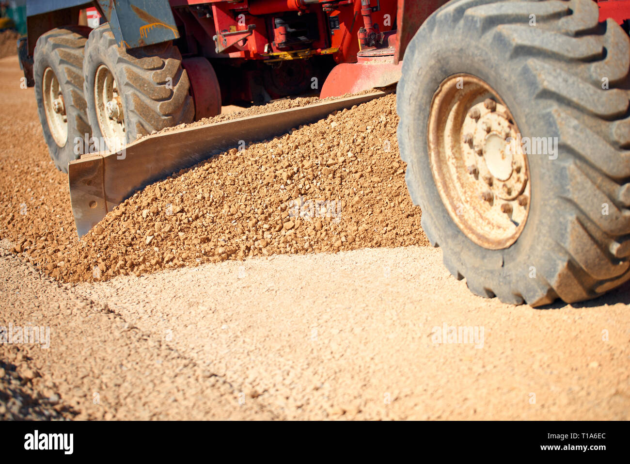 Road Grader Spreading Gravel On road Construction Site - Closeup view ...