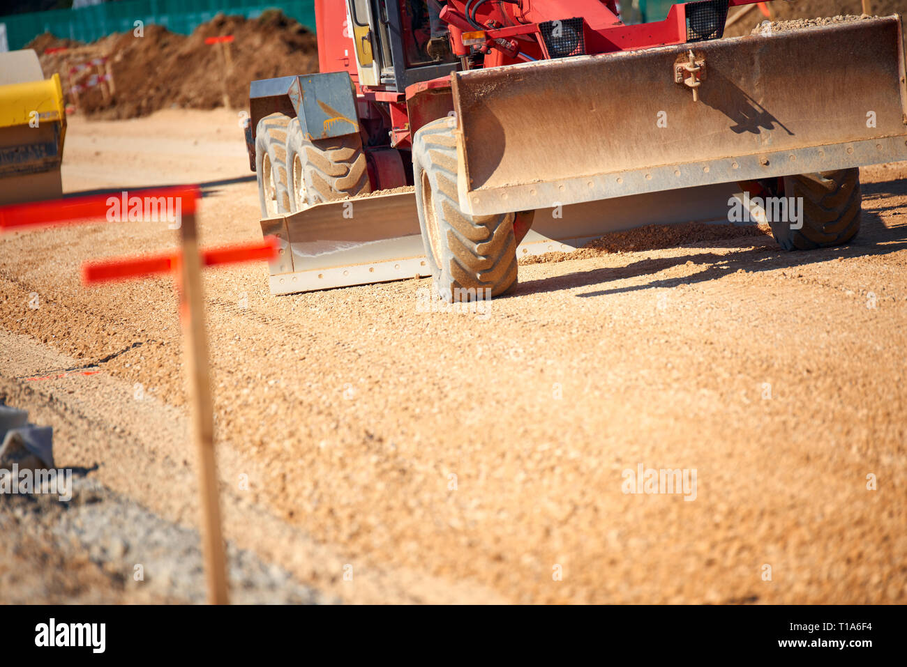 Road Grader Spreading Gravel On road Construction Site - Closeup view ...
