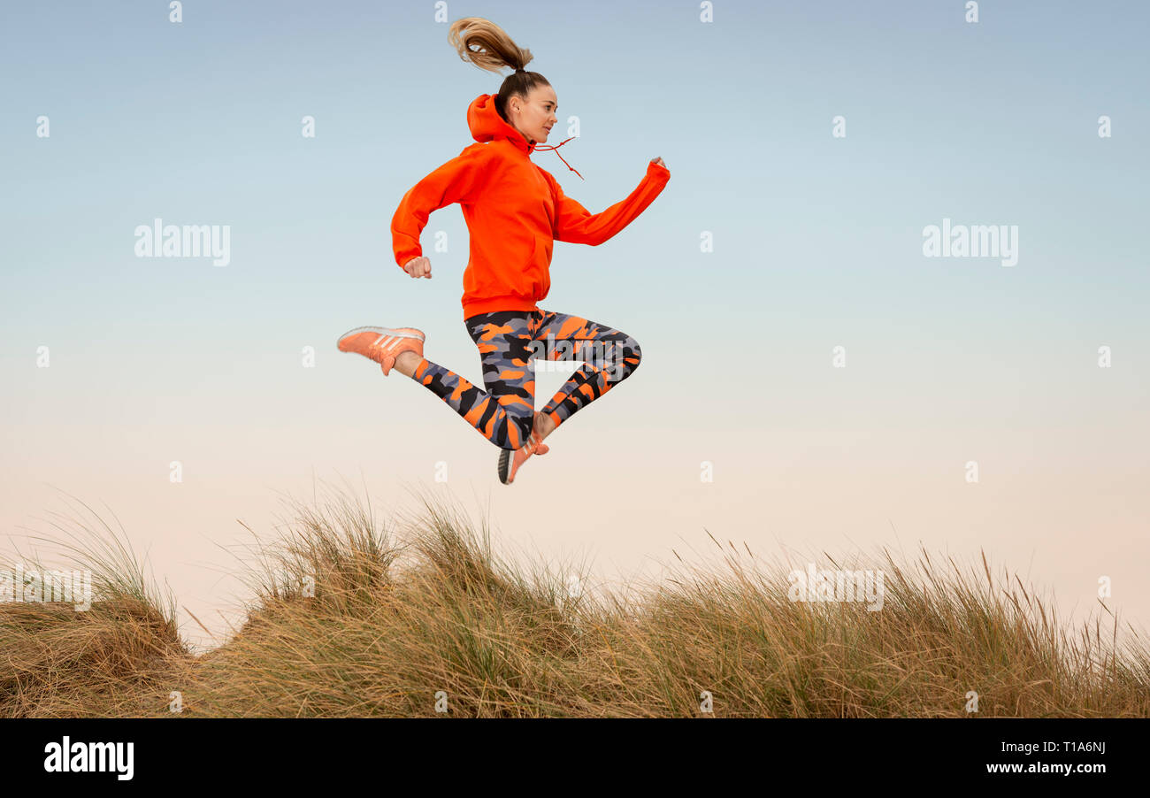 Woman outside run and jump hi-res stock photography and images - Alamy
