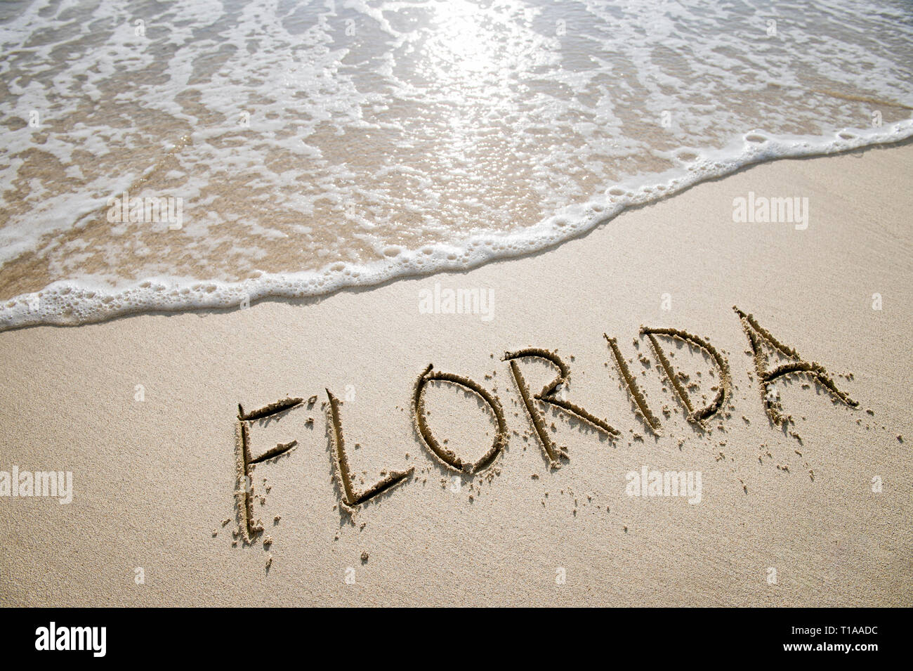 Simple Florida American holiday getaway message written in smooth sand ...