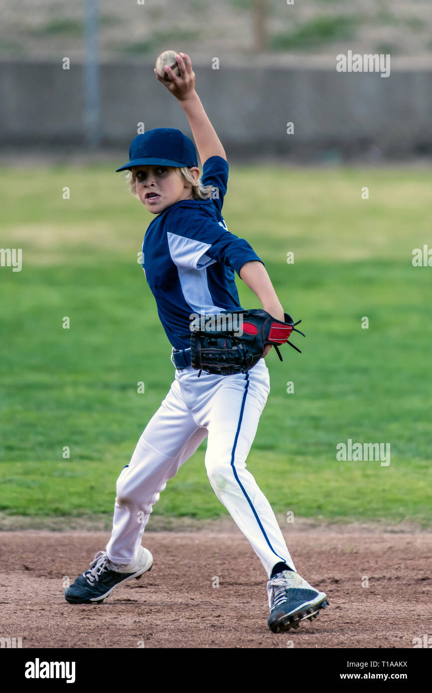 Little league short stop loaded and ready to throw ball across baseball ...