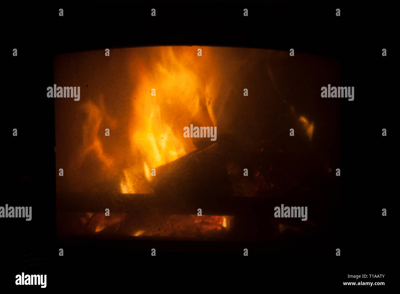 Warm fire burning in wood burning stove in cottage Stock Photo - Alamy