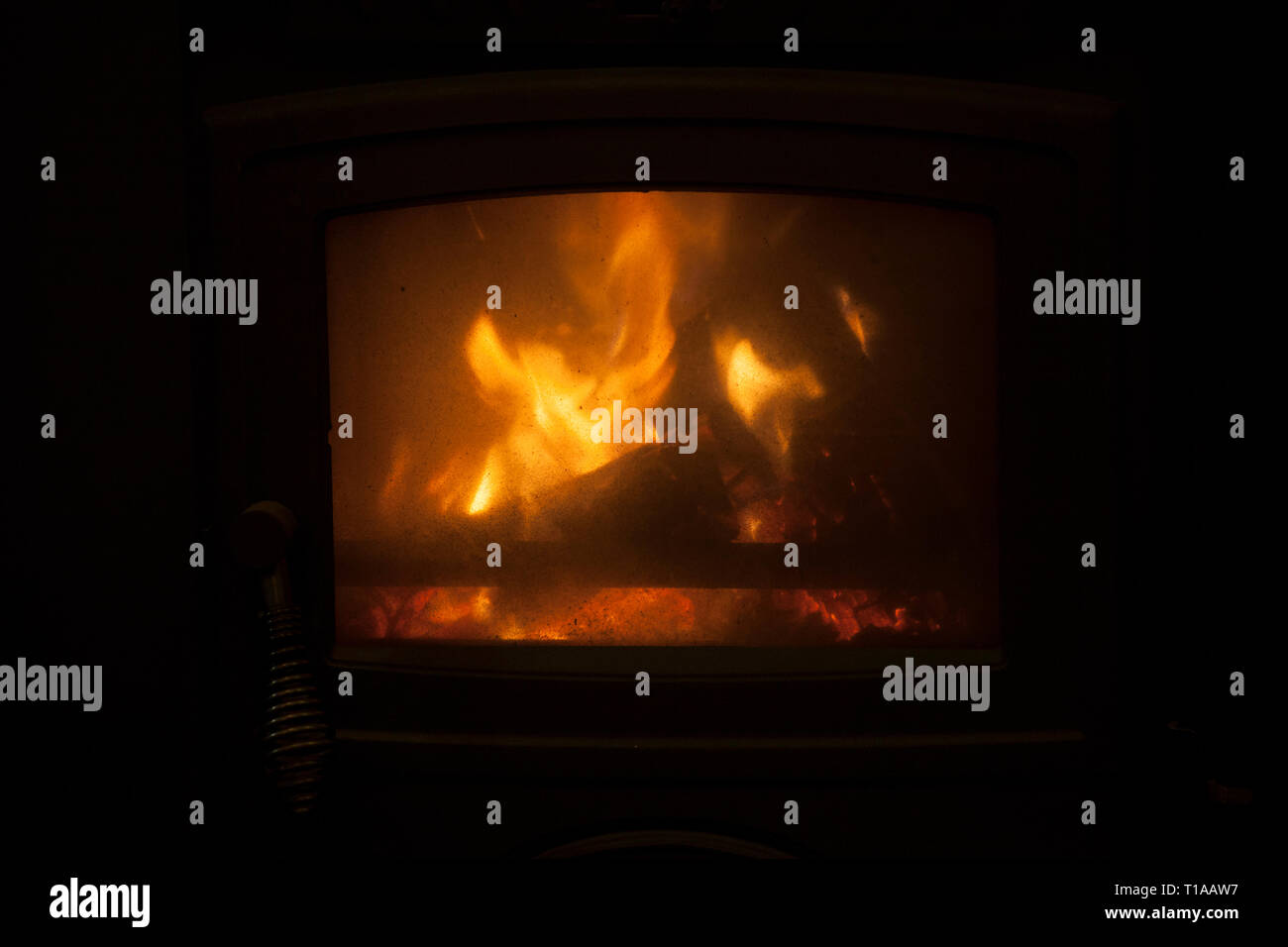 Warm fire burning in wood burning stove in cottage Stock Photo - Alamy