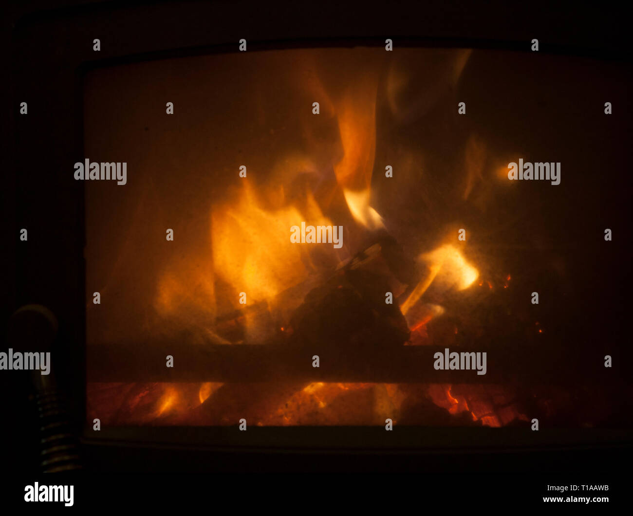 Warm fire burning in wood burning stove in cottage Stock Photo - Alamy
