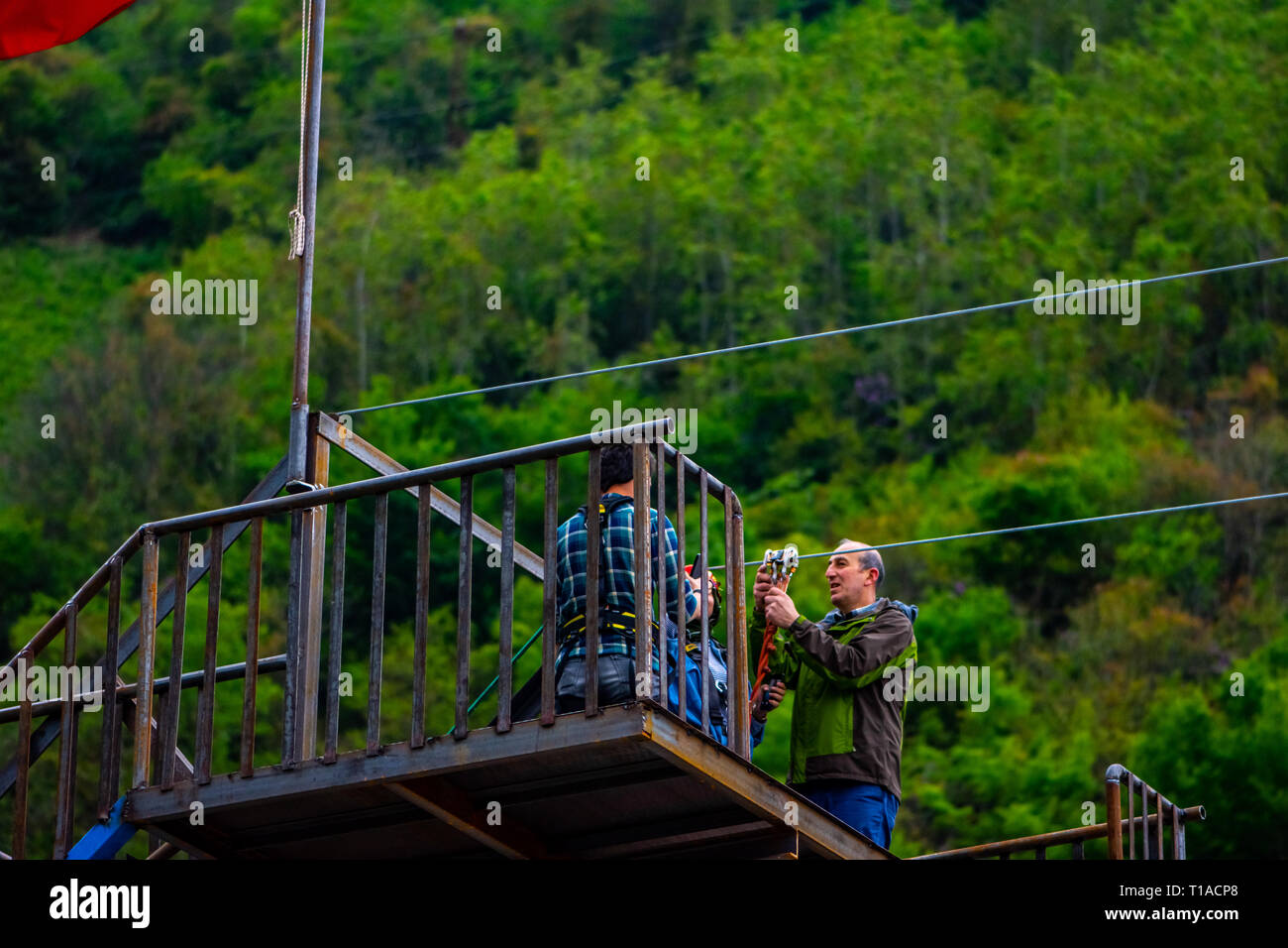 Worker preaparing boy to go to zip line, Trabzon Turkey 20 April 2018 ...